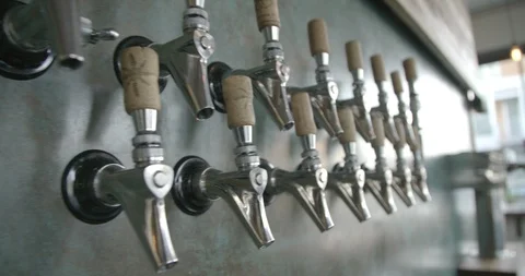 Dolly reveal of beer taps at bar or rest... | Stock Video | Pond5