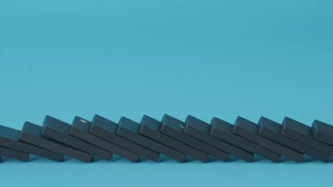 Domino effect, row of domino falling dow... | Stock Video | Pond5