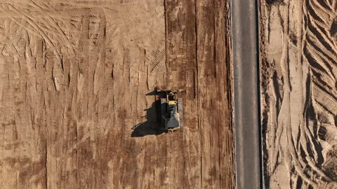 Dozer levelling the ground during road c... | Stock Video | Pond5