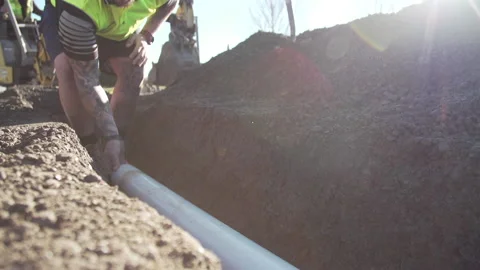 Drain layer placing pipe lens flare | Stock Video | Pond5