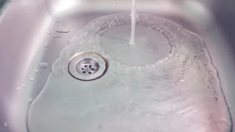 drain in metal sink. stream of water goi... | Stock Video | Pond5