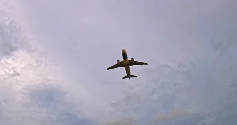 Dramatic view of flying airplane under b... | Stock Video | Pond5