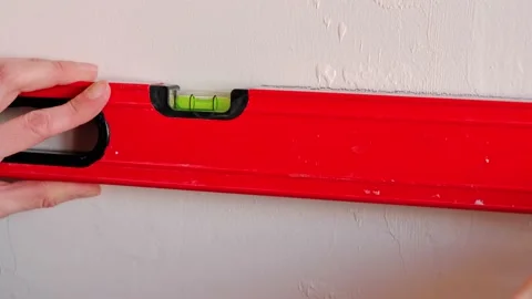 Drawing horizontal markings on the wall ... | Stock Video | Pond5