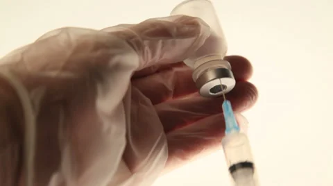 Drawing a medication from a vial with a ... | Stock Video | Pond5