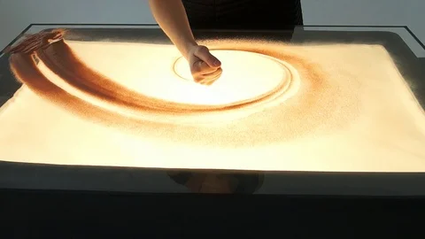 Drawing with sand. Drawing sand on a whi... | Stock Video | Pond5
