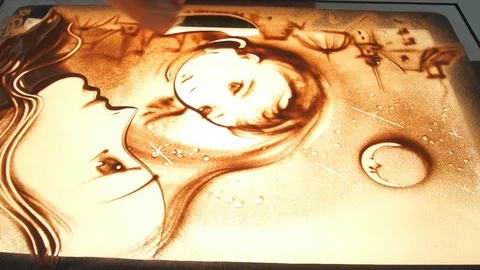 Drawing with sand. Drawing sand on a whi... | Stock Video | Pond5