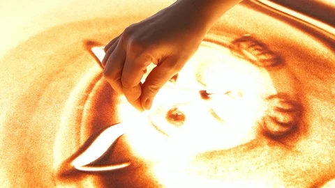 Drawing with sand. Drawing sand on a whi... | Stock Video | Pond5