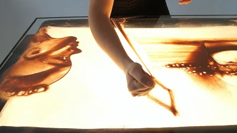 Drawing with sand. Drawing sand on a whi... | Stock Video | Pond5