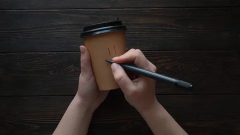 Drawing smiling face on a paper cup. Han... | Stock Video | Pond5