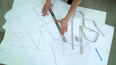 Dressmaker drawing sewing pattern on pap... | Stock Video | Pond5