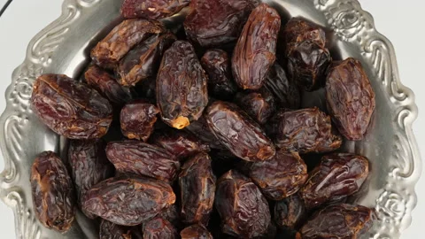 dried large dates on a metal plate that ... | Stock Video | Pond5