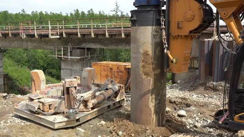 Drilling rig works to build a bridge in ... | Stock Video | Pond5