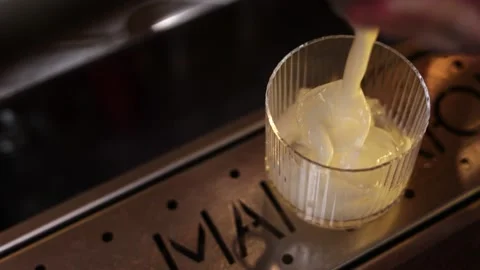 the drink pours into a glass slow motion... | Stock Video | Pond5