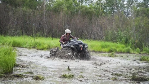 Drive ATV through swamp, water, mud and ... | Stock Video | Pond5