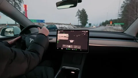 Driver navigating Tesla Model Y through ... | Stock Video | Pond5