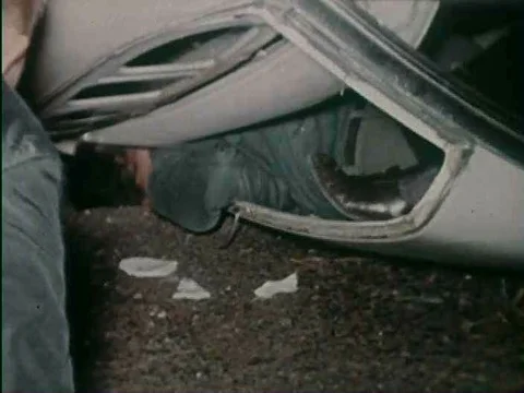 A driver, pinned under the wreck of his ... | Stock Video | Pond5