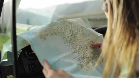Driver writing on paper map in car durin... | Stock Video | Pond5