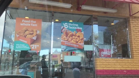 Driving Popeyes Restaurant Window Signag... | Stock Video | Pond5