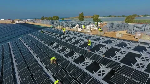 Drone approaches a solar array under con... | Stock Video | Pond5