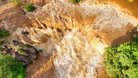 Drone captures dramatic waterfall flood | Stock Video | Pond5