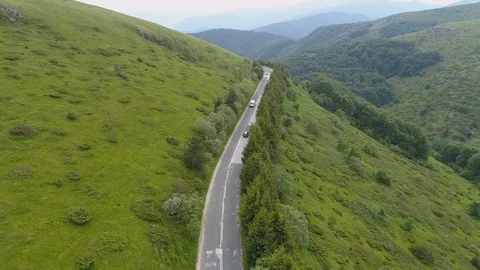 Drone chasing car and white truck on mou... | Stock Video | Pond5
