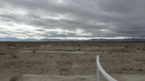 DRONE FLYING LOW IN DESERT LOW CLOUDS | Stock Video | Pond5