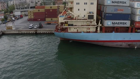 Drone flying past hull of docked cargo s... | Stock Video | Pond5