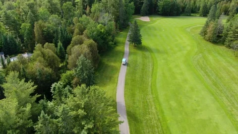 Drone following a golf cart driving on a... | Stock Video | Pond5