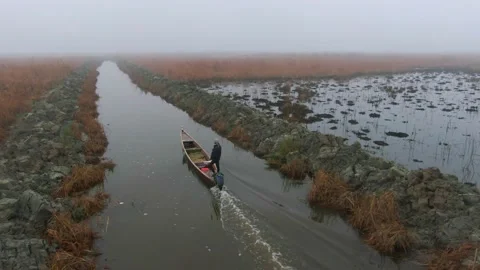 Drone follows man in mashoof canoe at fo... | Stock Video | Pond5