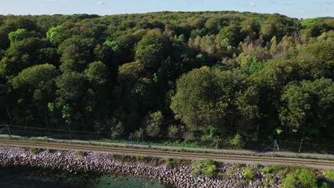 Drone Over Train Track Towards Lush Urba... | Stock Video | Pond5