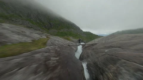 Drone Pilot flying under bridge above wa... | Stock Video | Pond5