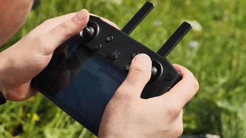 a drone pilot's hands operating remote c... | Stock Video | Pond5