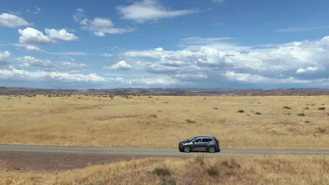Drone shot tracking a EV car driving in ... | Stock Video | Pond5
