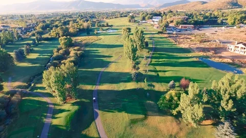 drone zoom in on golf cart to club house | Stock Video | Pond5
