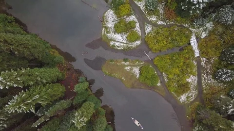 Drop down aerial rising upwards. Lake, r... | Stock Video | Pond5