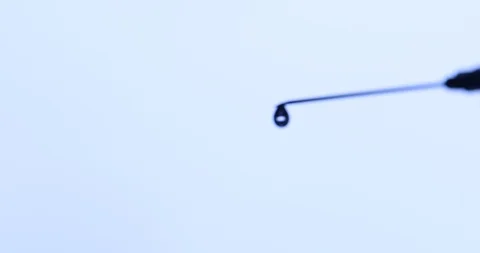 Drop falling from injection syringe | Stock Video | Pond5