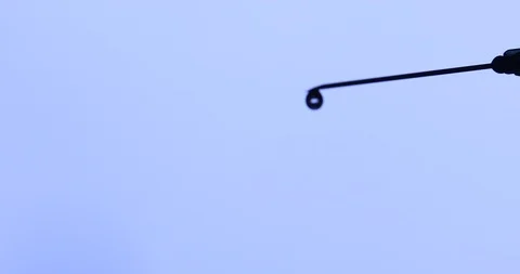 Drop falling from injection syringe | Stock Video | Pond5