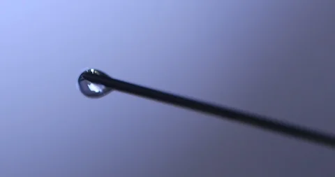 Drop falling from injection syringe | Stock Video | Pond5