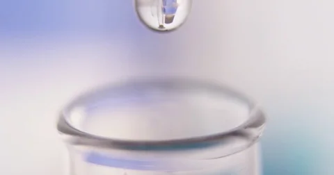 Drop is falling into test tube close up | Stock Video | Pond5