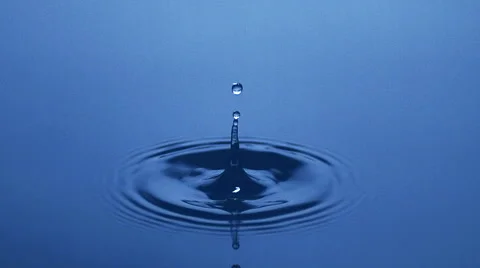 Drop of Water falling into Water against... | Stock Video | Pond5
