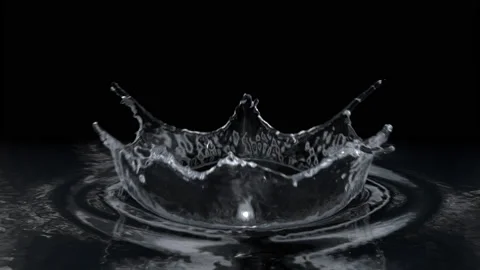 A drop of water makes a splash and rippl... | Stock Video | Pond5