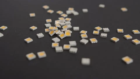 Dropping Small SMD LEDs on Black Backgro... | Stock Video | Pond5