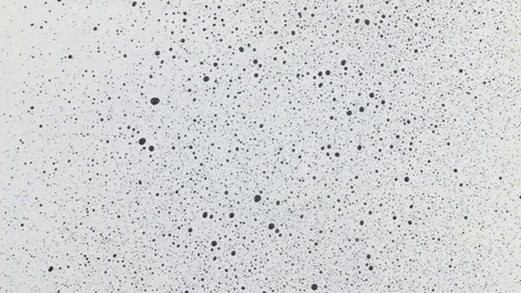 Drops of black paint falling on a white ... | Stock Video | Pond5