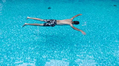 Drowned man floating in indoor swimming ... | Stock Video | Pond5