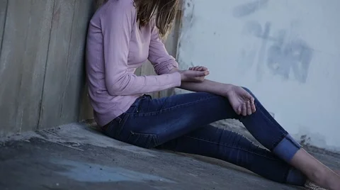 Drug addict girl sits, then falls, dropp... | Stock Video | Pond5