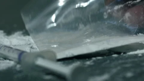 Drug addict preparing lines of heroin fo... | Stock Video | Pond5