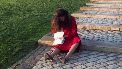 Drunk girl sitting on the steps in the p... | Stock Video | Pond5