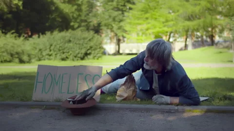 Drunk homeless man lying on lawn in park... | Stock Video | Pond5