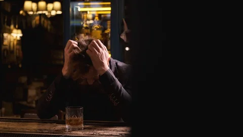 drunk man at bar with a glass of whiskey... | Stock Video | Pond5