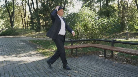 Drunk man comes to bench and fall on it ... | Stock Video | Pond5